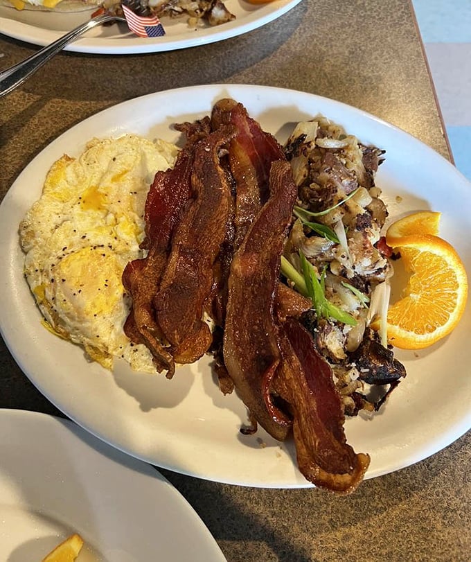 Thick-cut bacon, perfectly cooked eggs, and country potatoes—the holy trinity of breakfast that makes Monday mornings bearable again.