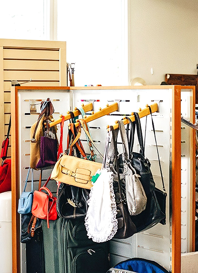 The handbag section resembles a fashionista's dream closet, with leather treasures and colorful statement pieces hanging in patient anticipation.