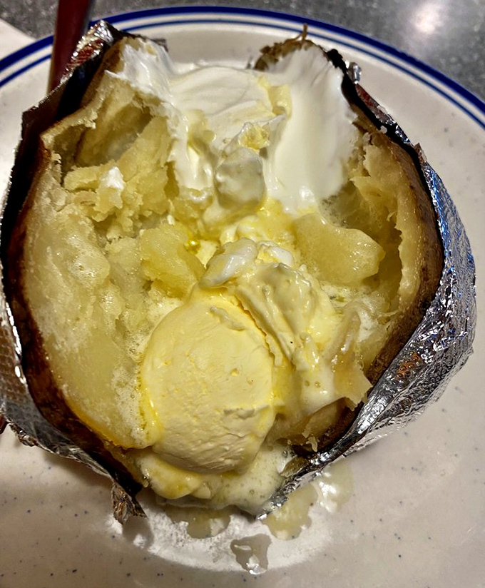 This baked potato isn't just loaded&mdash;it's having an identity crisis with all that butter melting into its fluffy innards.