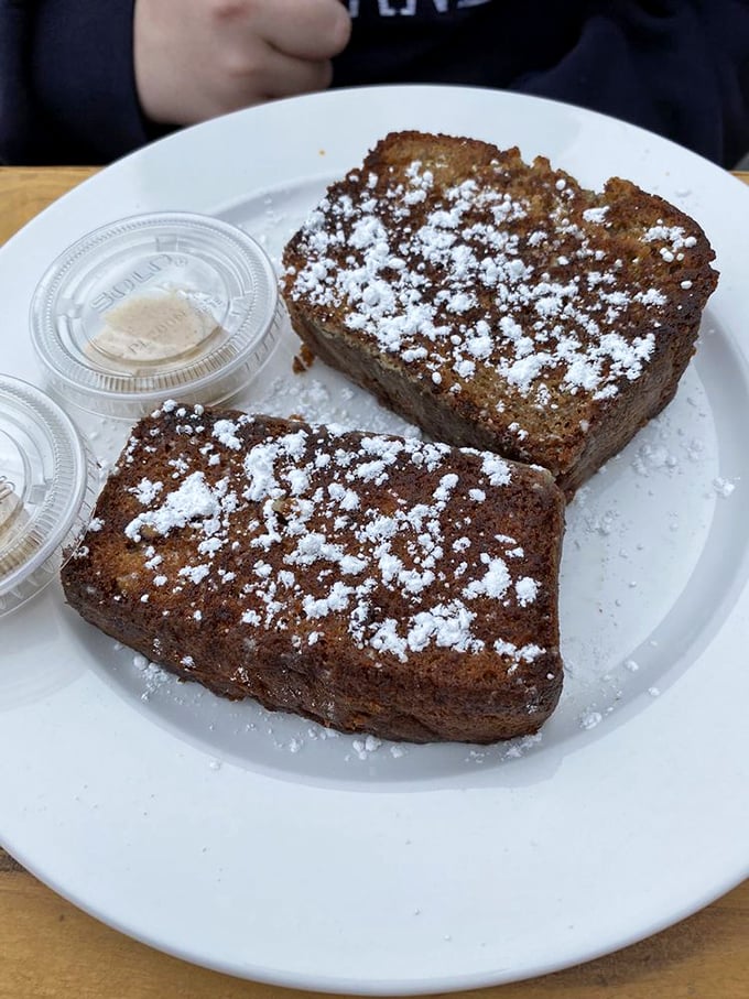 Banana bread dusted with powdered sugar&mdash;proof that sometimes the simplest pleasures are the ones worth crossing county lines for.