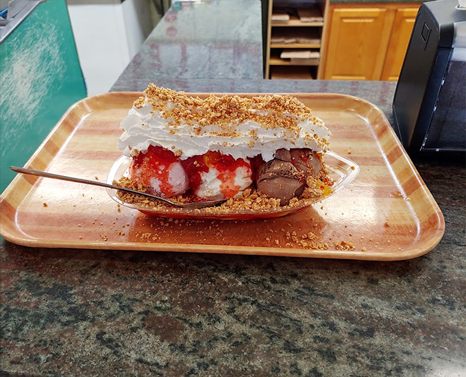 Behold the banana split&mdash;the architectural marvel of the dessert world. Graham cracker crumbs, whipped cream, and strategic berry placement create the perfect bite every time. 