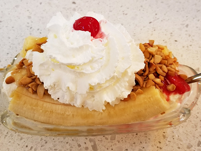 This banana split isn't just dessert; it's architecture, sculpture, and pure joy served in a glass boat of happiness.