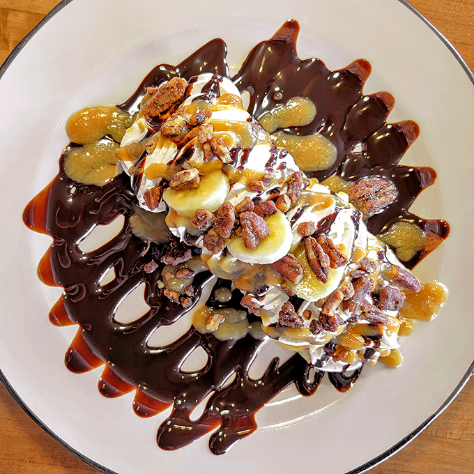 Dessert nirvana achieved: bananas, ice cream, chocolate, caramel, and candied pecans collide in a sweet spectacle that's worth every calorie-laden bite.