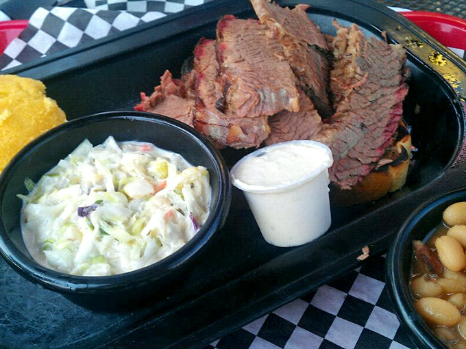 Brisket so tender it practically surrenders to your fork. The pink smoke ring is nature's way of saying "you've made an excellent life choice today."