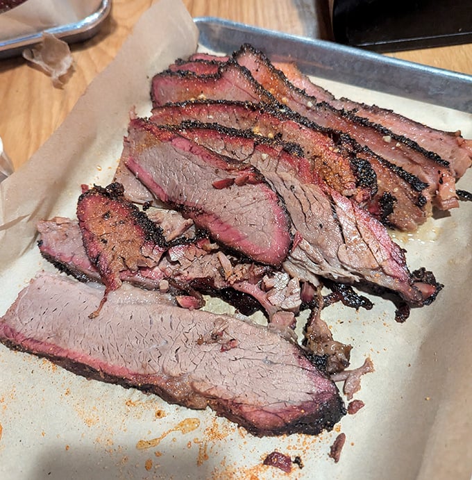 Brisket sliced so perfectly you could read a newspaper through it, with that telltale pink smoke ring that makes barbecue aficionados weak in the knees.
