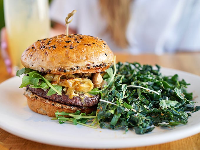 This isn't your average guilt-trip burger. The grass-fed patty nestled on a seeded bun with fresh greens proves healthy eating can still be gloriously indulgent.