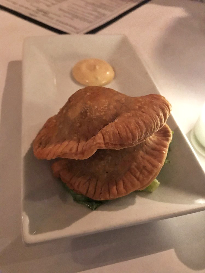 Empanadas with perfectly crimped edges that seal in all the savory goodness. The accompanying sauce adds a tangy counterpoint that makes taste buds stand at attention.