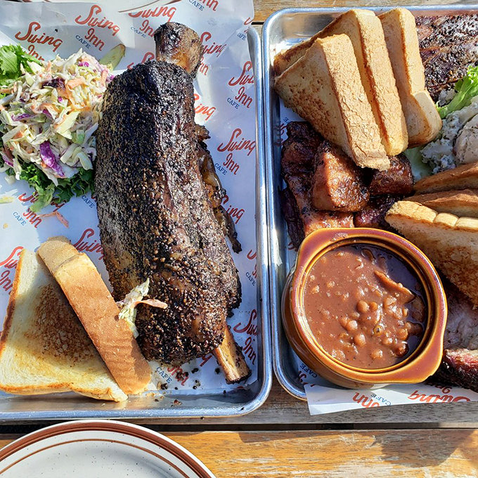 Beef ribs so substantial they could double as caveman clubs, glistening with smoky perfection.