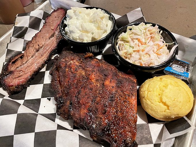 The holy trinity of barbecue perfection: brisket with that telltale smoke ring, creamy potato salad, and cornbread that doesn't know it's not dessert.
