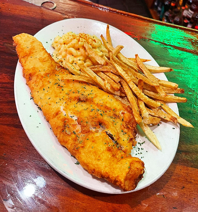 Fish so perfectly golden-fried it deserves its own trophy. The mac and cheese sidekick isn't playing second fiddle&mdash;it's conducting its own creamy orchestra.