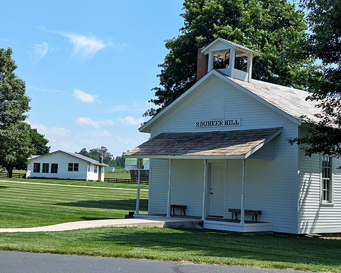The pristine white Sprunger Hill schoolhouse stands as a testament to simplicity, making you wonder if education was somehow clearer when distractions were fewer.