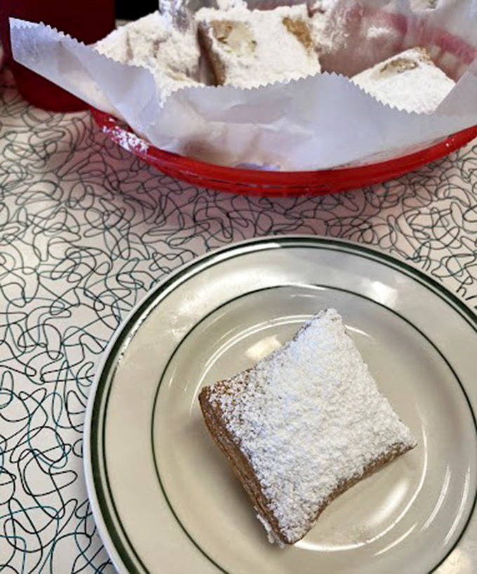 Powdered sugar blizzards on these beignets create the kind of sweet moment that makes you forget your diet resolutions faster than you can say "dessert."