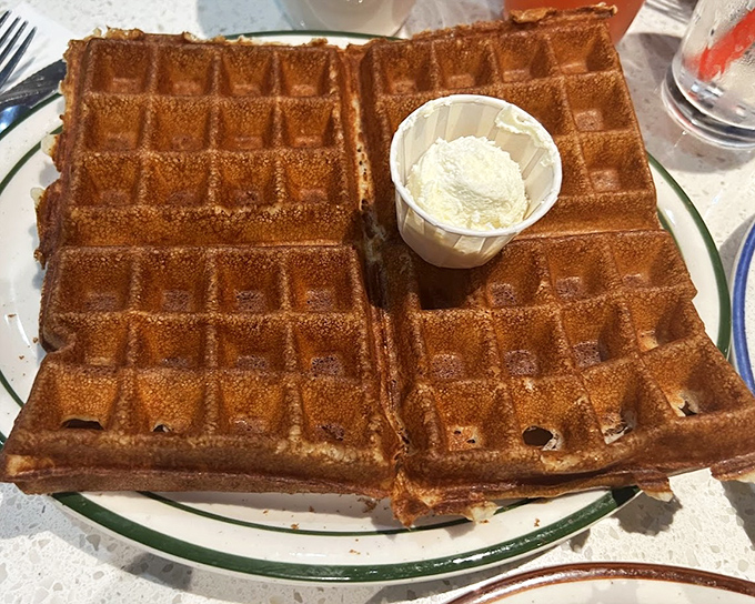 These golden-brown waffles aren't just breakfast, they're an architectural marvel of crispy exterior and fluffy interior. Butter melting into every perfect pocket.
