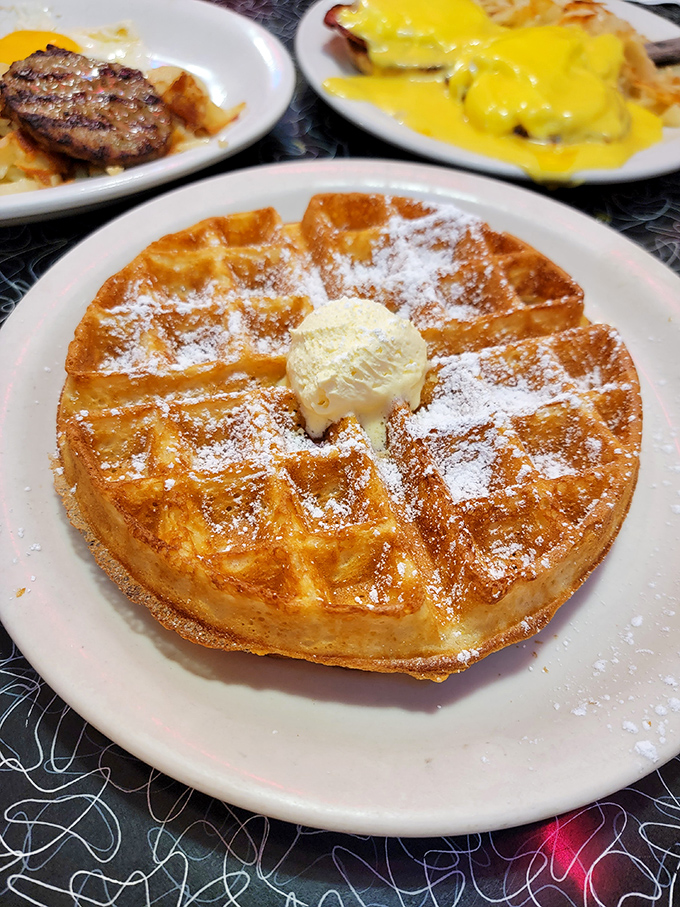This golden waffle doesn't just wear its powdered sugar like a dusting of snow&mdash;it practically demands a moment of silent appreciation before diving in.