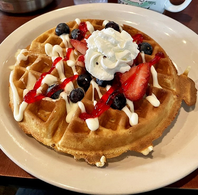 This Belgian waffle doesn't just have toppings&mdash;it's wearing a crown of berries, cream, and syrup fit for breakfast royalty.