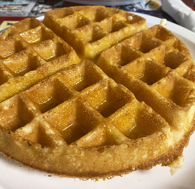 This golden Belgian waffle doesn't need a passport to impress. Each perfect square holds just enough maple syrup to make breakfast feel like a celebration.