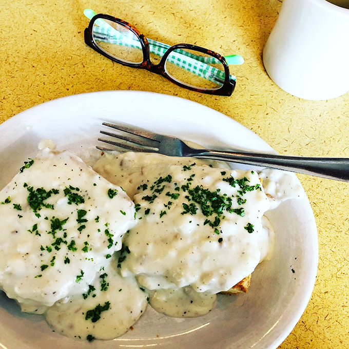 These biscuits and gravy aren't just a meal&mdash;they're an experience. Creamy, herb-flecked gravy cascading over pillowy biscuits like a comfort food waterfall.