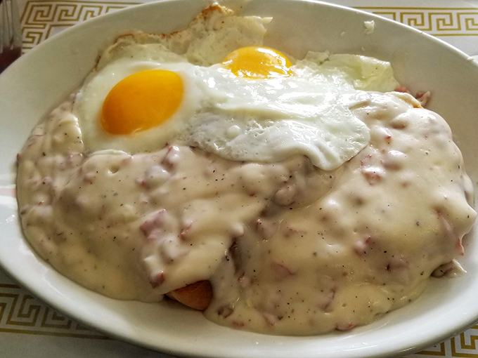 Biscuits and gravy topped with a sunny-side-up egg&mdash;comfort food that hugs your soul. The pepper specks in that gravy promise flavor that grandma would approve of.