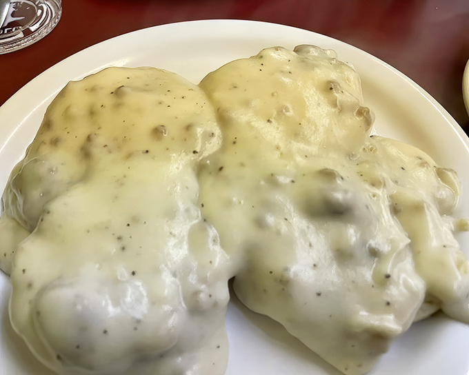 Biscuits and gravy: where Southern comfort meets Midwestern hospitality in a creamy, peppery embrace that makes you forget about cholesterol counts.