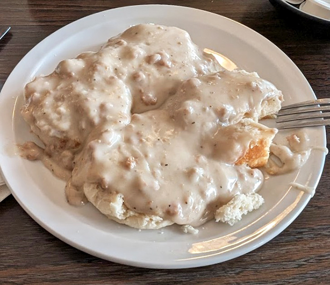 Biscuits drowning in gravy like they're taking the world's most delicious bath.