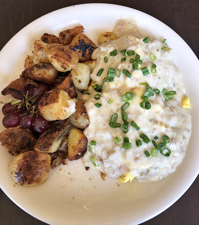 This isn't just breakfast; it's edible therapy. Creamy biscuits and gravy with perfectly roasted potatoes that could solve most of life's problems.