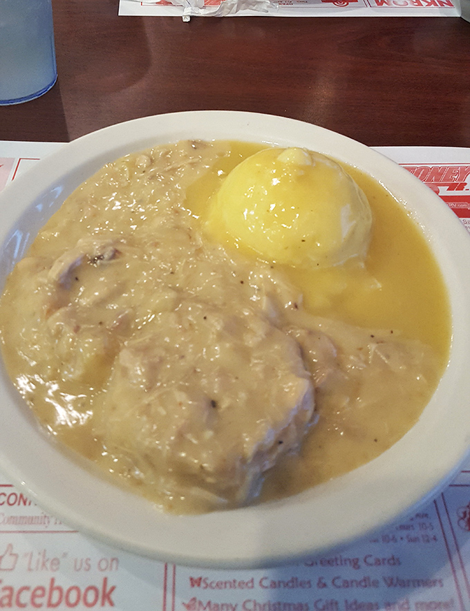 Hot roast beef swimming in rich gravy alongside a golden-topped baked potato&mdash;comfort food that hugs your soul on a plate.