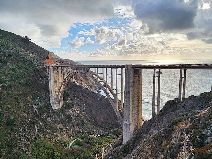 Engineering marvel meets natural wonder at Bixby Bridge. Like a concrete rainbow arching over the rugged canyon, it's been photobombing vacation albums since 1932.