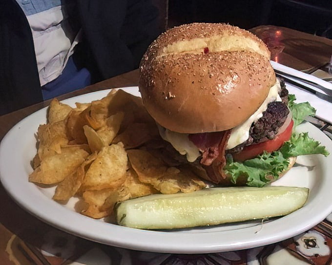 A burger that demands respect and a strategy. The sesame seed bun valiantly attempts to contain what can only be described as controlled chaos.
