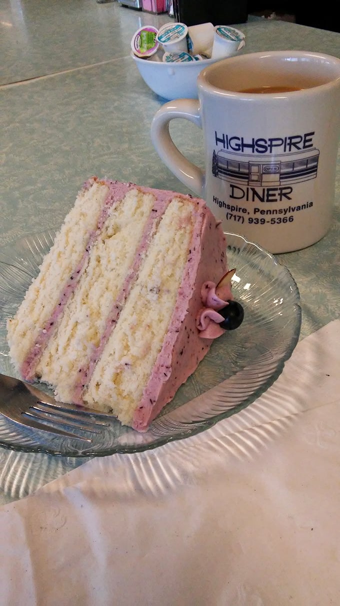 A slice of berry-infused heaven paired with coffee in a mug that's seen thousands of refills and morning conversations.