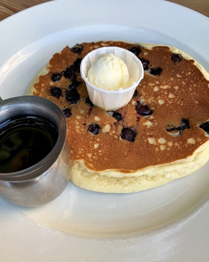 These blueberry pancakes aren't just breakfast, they're edible sunshine&mdash;complete with butter melting into every nook and a side of maple syrup.