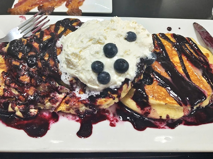 These blueberry pancakes don't just look good&mdash;they're practically auditioning for a breakfast hall of fame with that perfect whipped cream crown.