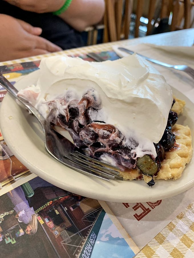 Blueberry pie that's having an identity crisis as a cloud. That mountain of whipped cream isn't just a topping&mdash;it's the crown jewel of the Yoder's experience.