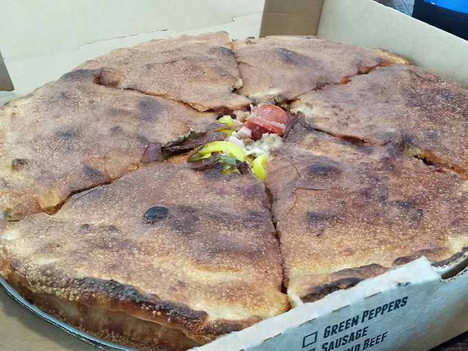 This stuffed pizza isn't just a meal, it's an engineering marvel with a perfect ratio of crust-to-filling that defies physics.