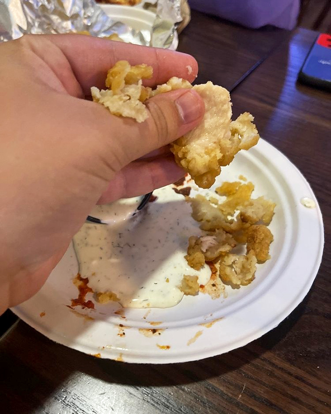 Golden-fried perfection waiting for its ranch bath. These crispy morsels disappear faster than your vacation days.