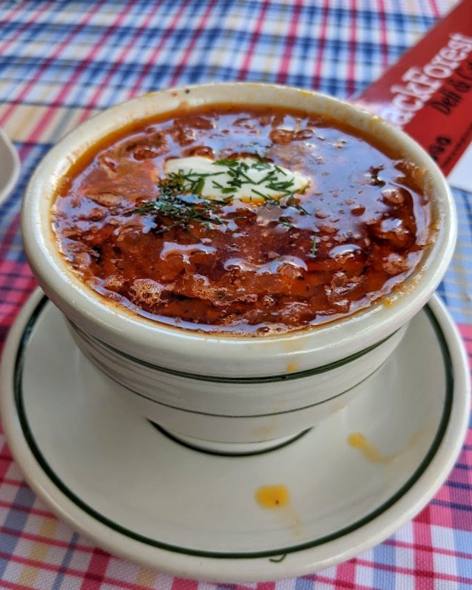 Borscht so vibrant it could double as modern art. That dollop of sour cream slowly melting into the crimson broth is the culinary equivalent of a perfect sunset.