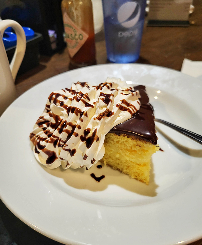 Boston cream pie that would make Massachusetts jealous. The chocolate glaze and whipped cream drizzle are performing a sweet duet.
