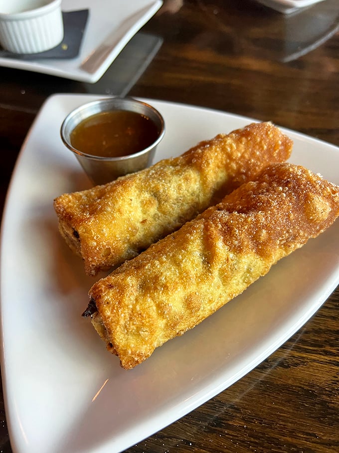 Egg rolls reimagined as vessels of pure indulgence&mdash;crispy wrappers giving way to savory fillings with a side of dipping sauce that makes you question why you'd ever order them anywhere else.
