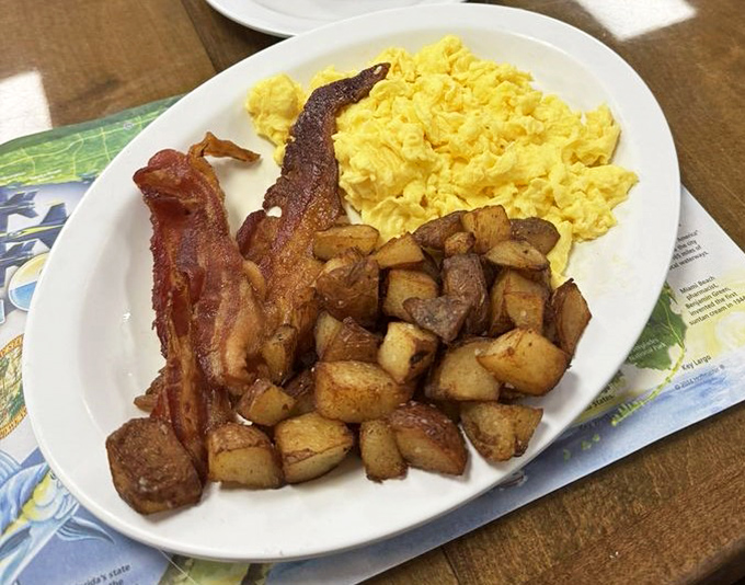 The breakfast trinity &ndash; crispy bacon, fluffy scrambled eggs, and home fries that would make your grandmother nod in silent approval.