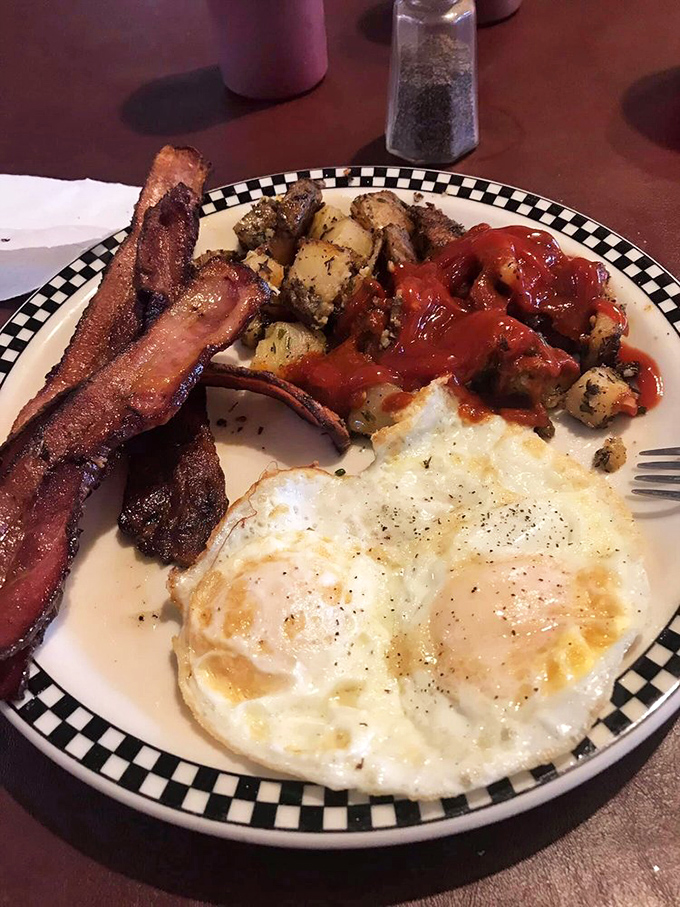 Breakfast perfection: eggs with edges crispy enough to make a statement, potatoes seasoned by someone who clearly loves you, and bacon that deserves its own fan club.