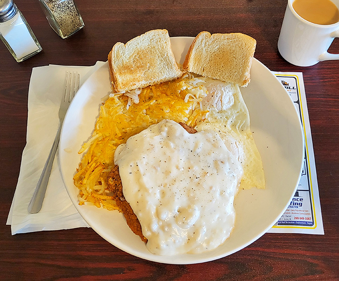 Country breakfast nirvana: hash browns under a blanket of country gravy, with toast standing by to mop up what your fork can't handle.