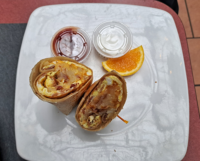 The legendary breakfast burrito in its natural habitat, flanked by dipping companions. This isn't just breakfast&mdash;it's edible architecture.
