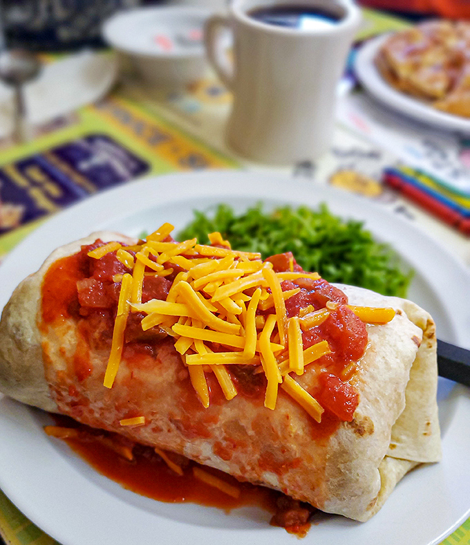 The breakfast burrito &ndash; where morning ingredients have a fiesta wrapped in a tortilla blanket, topped with a cheese confetti celebration.