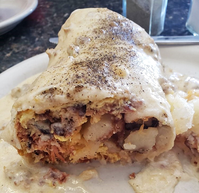 This breakfast burrito doesn't just break fast—it shatters expectations. Stuffed with savory goodness and smothered in country gravy that would make your grandmother jealous.