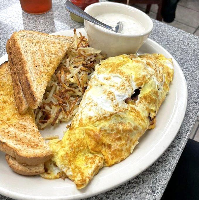 A perfect omelet, crispy hash browns, and toast&mdash;the breakfast trinity that proves morning meals aren't just for mornings.