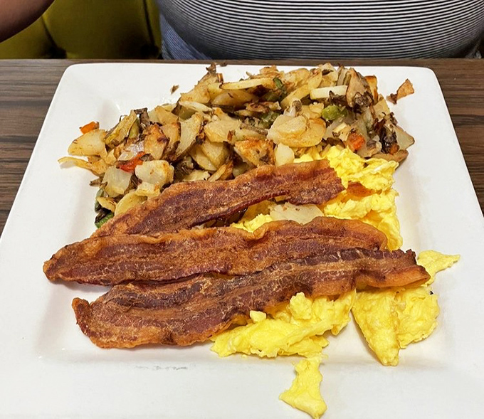 Crispy bacon, fluffy scrambled eggs, and seasoned potatoes &ndash; the holy trinity of breakfast done right at this Santa Ana gem.