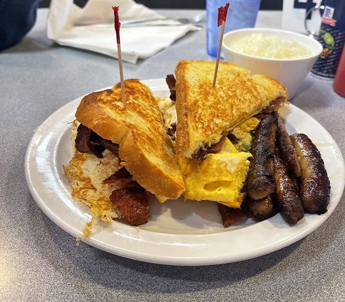 Breakfast sandwich architecture at its finest: golden toast, fluffy eggs, and bacon that clearly didn't get the memo about moderation.