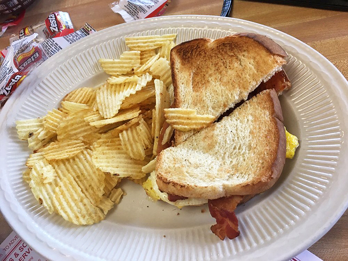 This isn't just a breakfast sandwich; it's morning architecture &ndash; golden toast, crispy bacon, and eggs, with potato chips standing guard.
