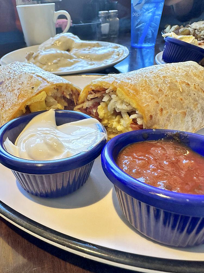 Breakfast burritos: where morning meets miracle. This handheld masterpiece comes with the perfect supporting cast of salsa and sour cream.