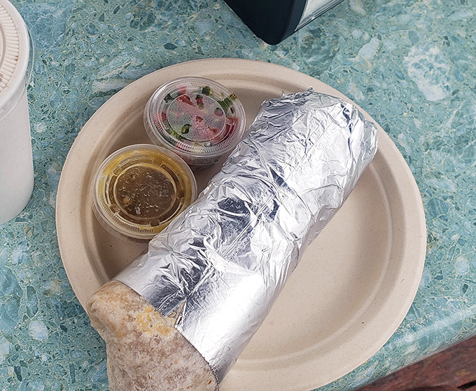 Wrapped in foil like the precious treasure it is, this breakfast burrito promises the kind of morning satisfaction that makes hitting the snooze button seem like a crime.