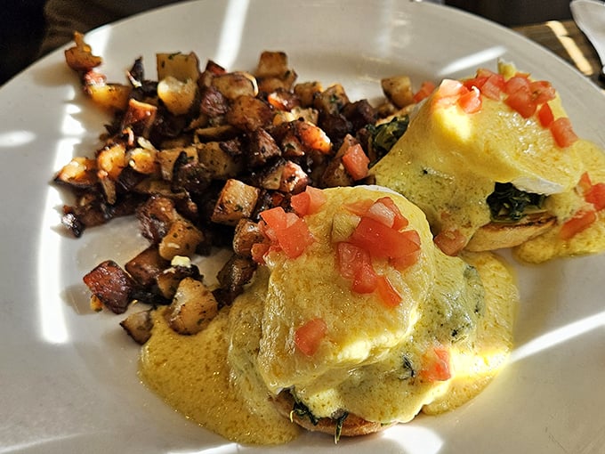 Breakfast benedicts that would make your cardiologist wince and your soul sing, paired with perfectly crispy home fries.